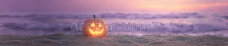 Glowing Jack O Lantern on Sandy Beach at Sunset for Halloween ...