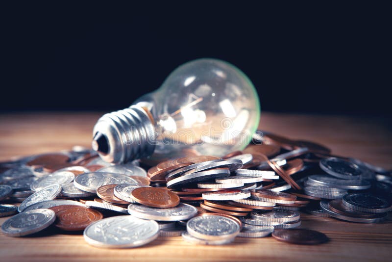 Glowing lamp and coins stock image. Image of currency - 217302873