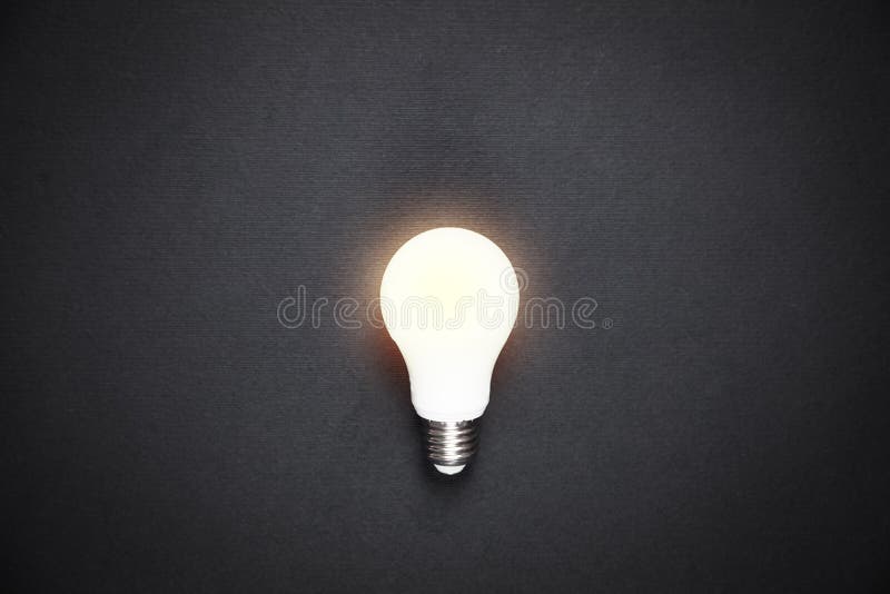 Glowing Light Bulb in the Black Background Stock Photo - Image of ...