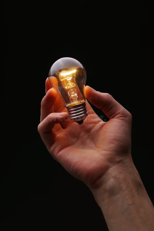 Glowing Light Bulb In Hand On A Dark Background. Stock Image - Image of ...