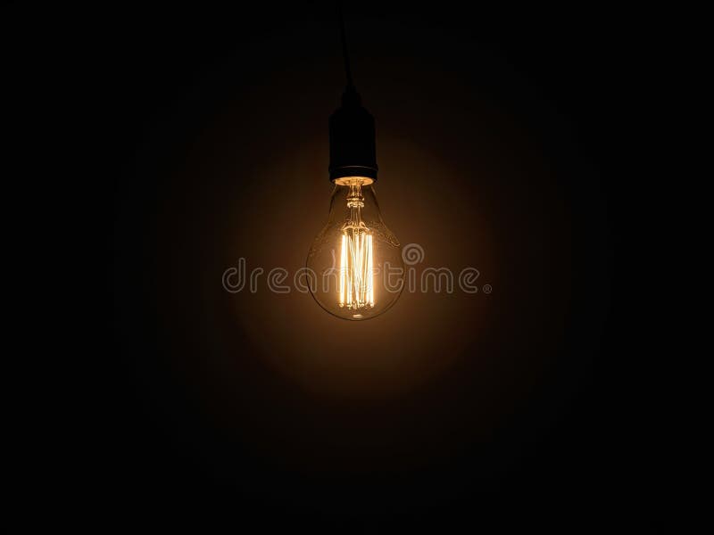 A Glowing Light Bulb Illuminates a Dark Space Stock Image - Image of ...