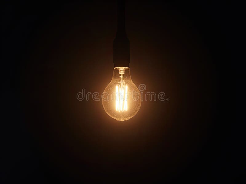 A Glowing Light Bulb Illuminates a Dark Space Stock Photo - Image of ...