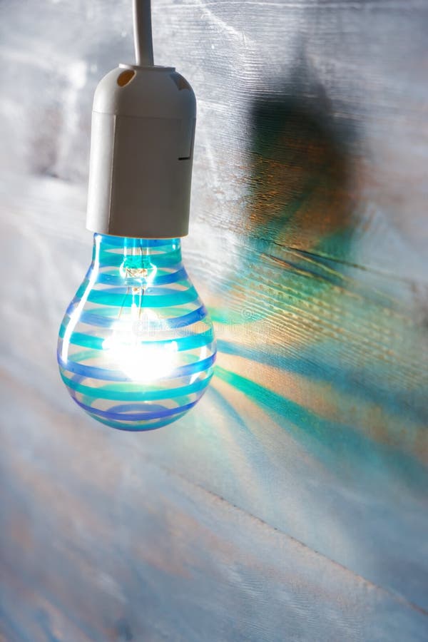 Glowing Light Bulb Near Wooden Wall Stock Photo - Image of decor, bulb ...
