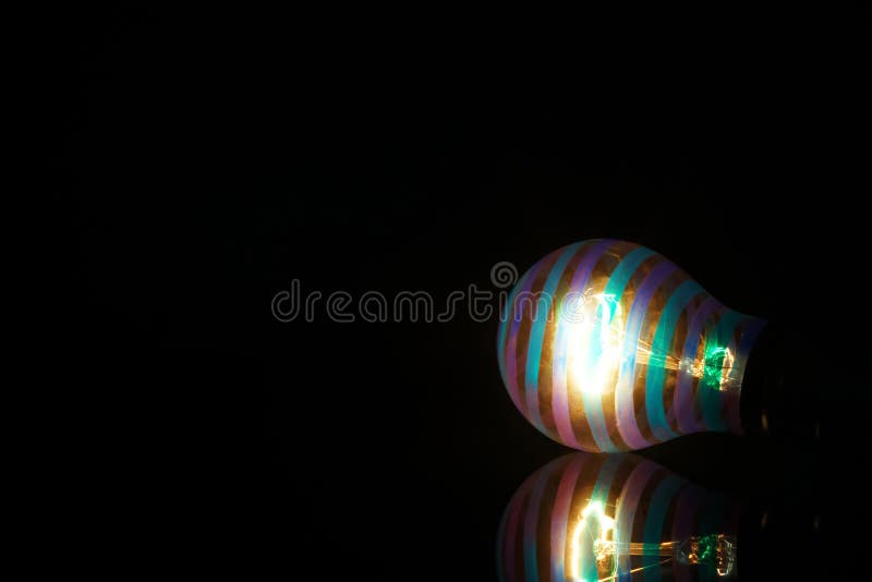 Glowing Light Bulb with Reflection on Black Background Stock Photo ...