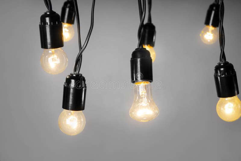 Glowing Light Bulbs on Grey Background Stock Photo - Image of lightbulb ...