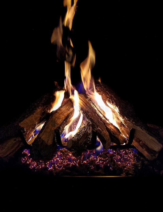 Burning logs in fireplace stock photo. Image of yellow - 130633072