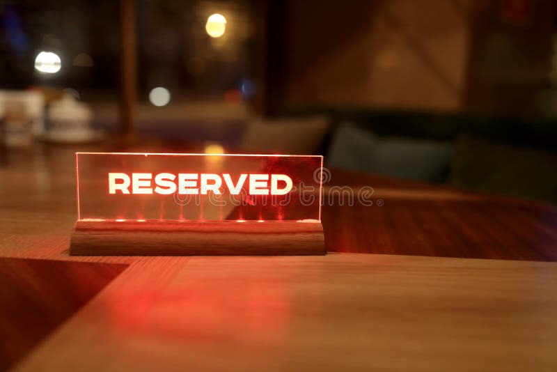 Glowing red sign reserved stock photo. Image of dark - 142227824