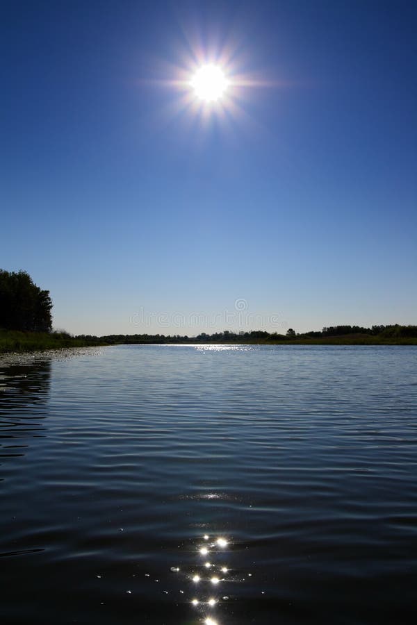 Glowing sun over lake stock photo. Image of landscape - 10015698