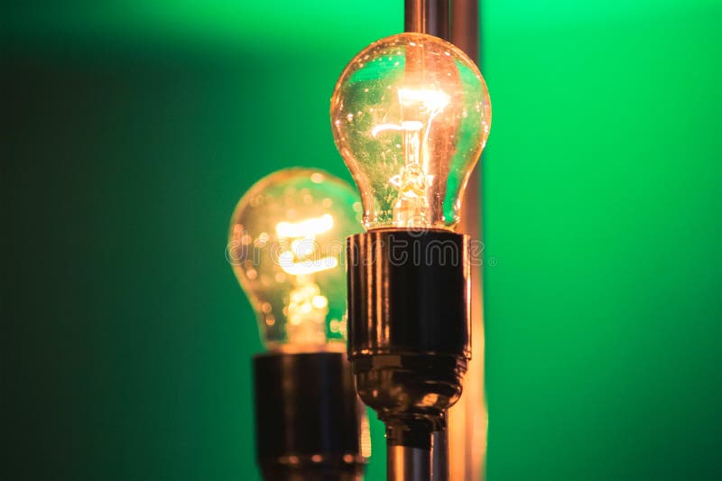 Glowing Light Bulb Against Blue Wall Background Stock Image - Image of ...