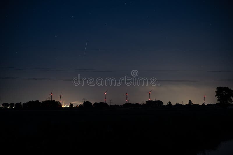 Glowing Wind Turbines with Their Red Lights on the Horizon in the Dark ...