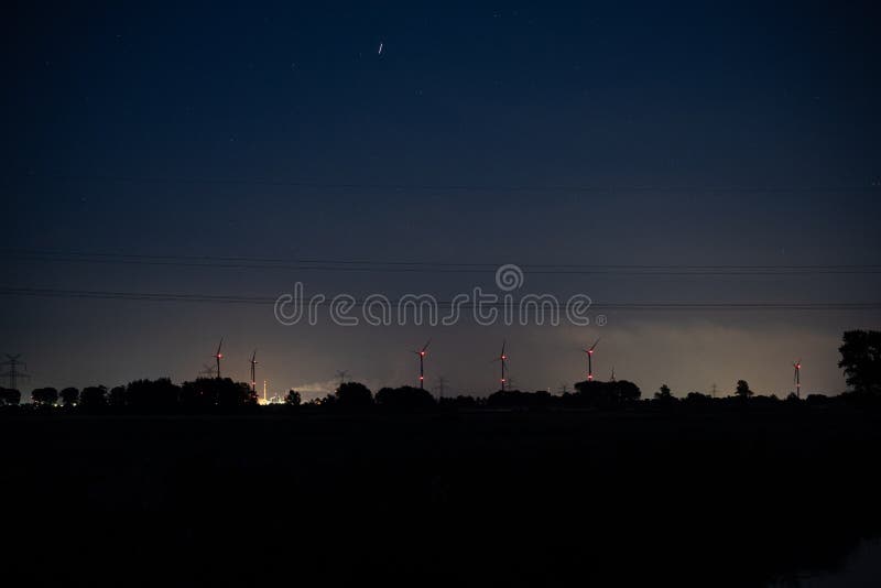 Glowing Wind Turbines with Their Red Lights on the Horizon in the Dark ...