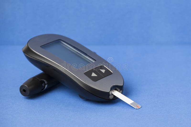 Glucometer with a Needle on a Blue Background. Measurement of Blood ...