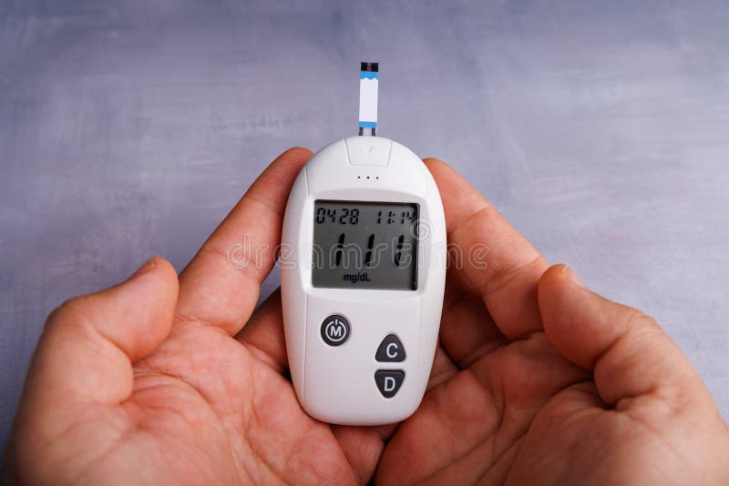 Glucometer in a Person S Hands Revealing Test Results on a Concrete ...