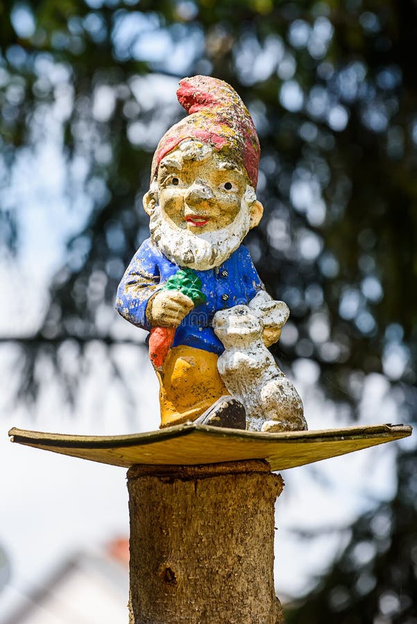 A Gnome Dwarf Statue in the Garden Stock Image - Image of happiness ...