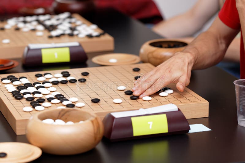 Playing go stock image. Image of indoors, people, player - 99160645