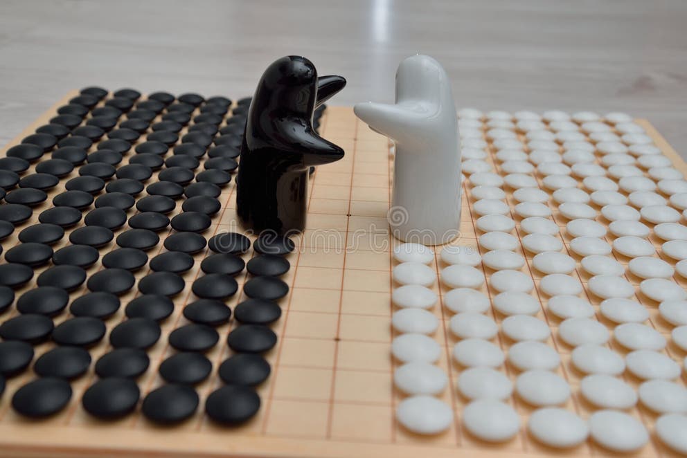 Go Game Pieces and Two Black and White Figures Stock Image - Image of ...