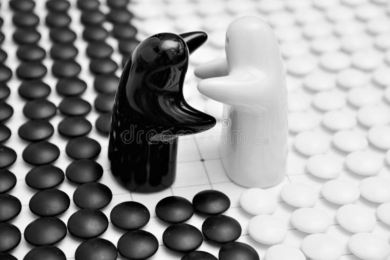 Go Game Pieces and Two Black and White Figures Stock Photo - Image of ...