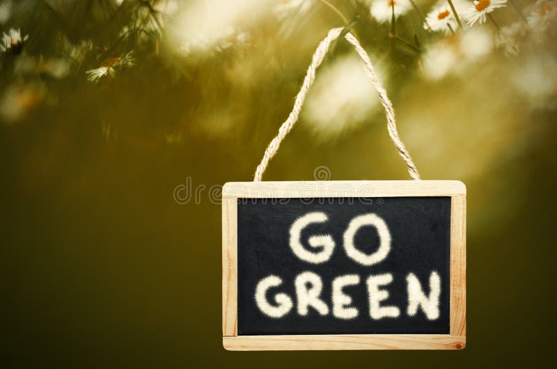 Go Green Written on Black Chalk Board Hanging from a Tree. Stock Image ...