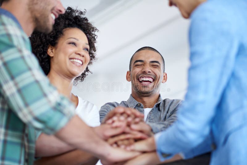 Go Team. a Smiling Group of Coworkers Standing in a Huddle in an Office ...