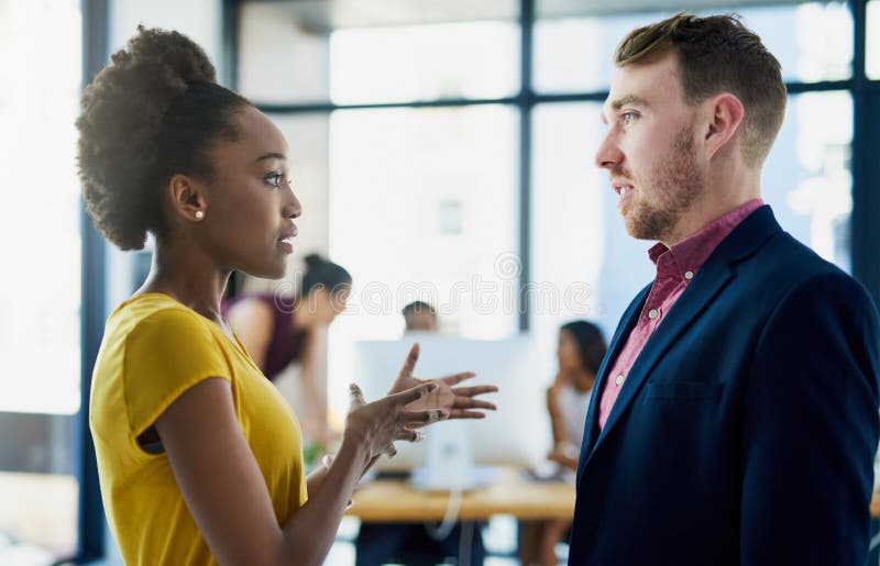 Before we Go in...two Corporate Businesspeople Talking in the Office ...