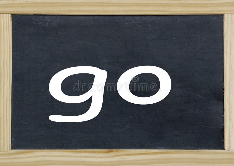 Go written on a chalkboard stock image. Image of grey - 189208657