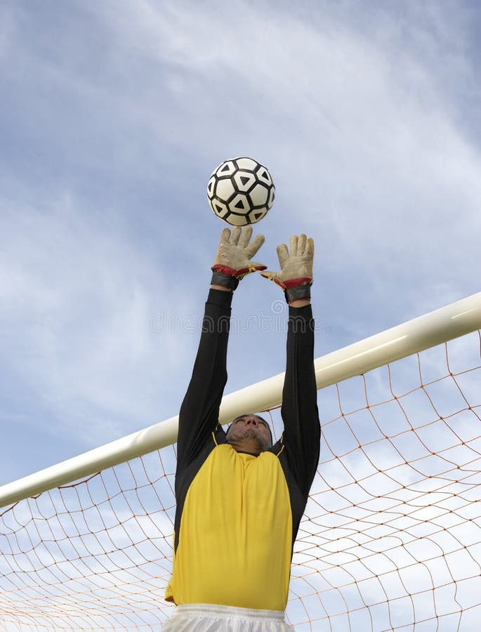 Goalkeeper Jumping To Catch the Ball Stock Photo - Image of latin, play ...