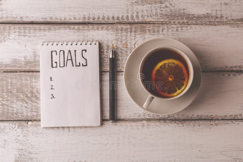 Goals Concept. Notebook with Goals List, Cup of Tea on Wooden Table ...