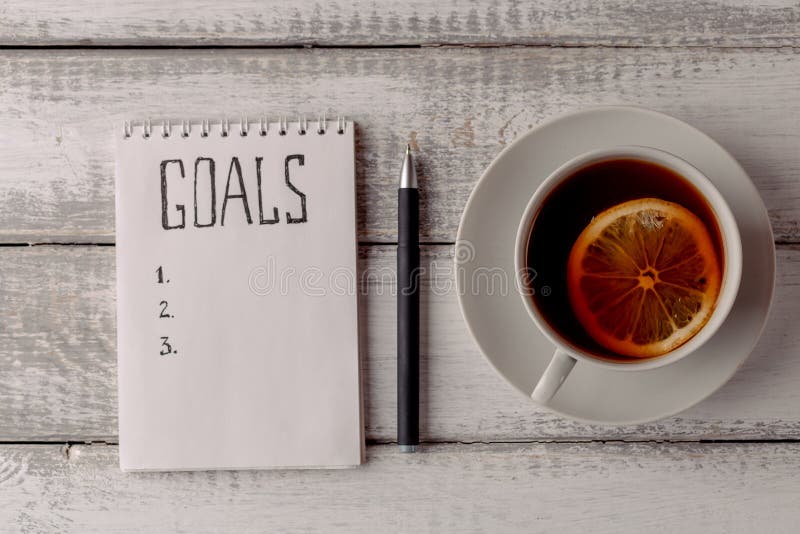 Goals Concept. Notebook with Goals List, Cup of Tea on Wooden Table ...