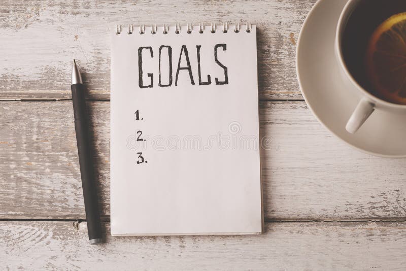 Goals Concept. Notebook with Goals List, Cup of Tea on Wooden Table ...