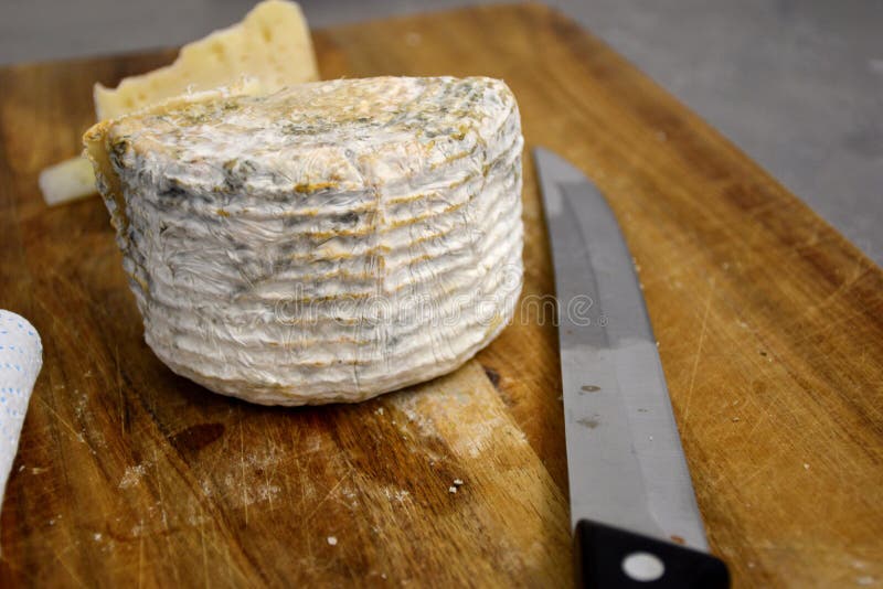 Goat Cheese Cut in Half on Wooden Board with Knife. Stock Image - Image ...