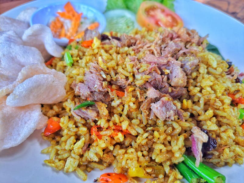 Goat Fried Rice Served with Lettuce, Sliced ??tomatoes and Cucumber ...