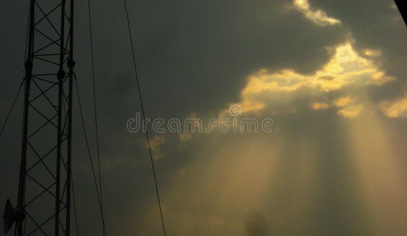 God Rays from Sunset Clouds Lighting a Tower Stock Image - Image of ...