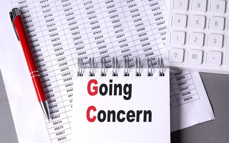 GOING CONCERN Text on Notebook with Chart , Pen and Calculator Stock ...