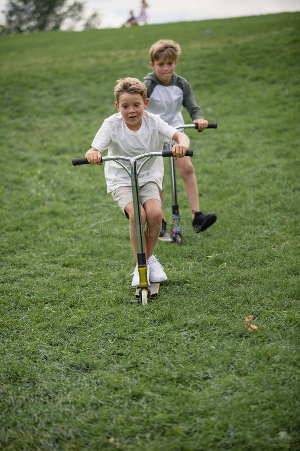 Going Down Hill on Scooters Stock Image - Image of enjoyment, carefree ...