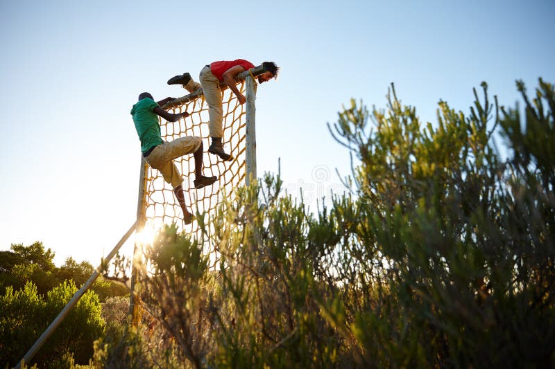Going at it with Everything Theyve Got. Two Men Going Over an Obstacle ...