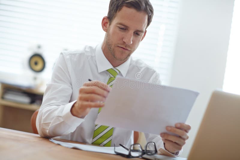 Going Over the Annual Figures. a Young Businessman Looking at a ...