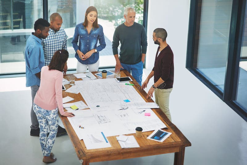 Going Over the Details. High Angle of a Group of Architects Looking ...