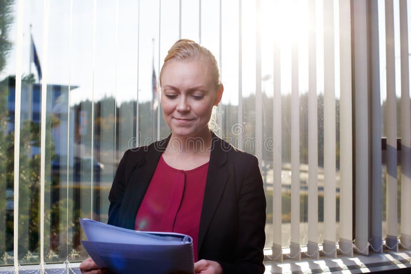 Going Over the Paperwork. an Attractive Businesswoman Reading Documents ...
