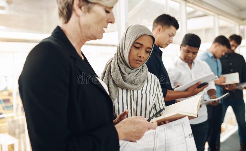 Going Over Some Notes. a Group of Business Colleagues Looking Over ...