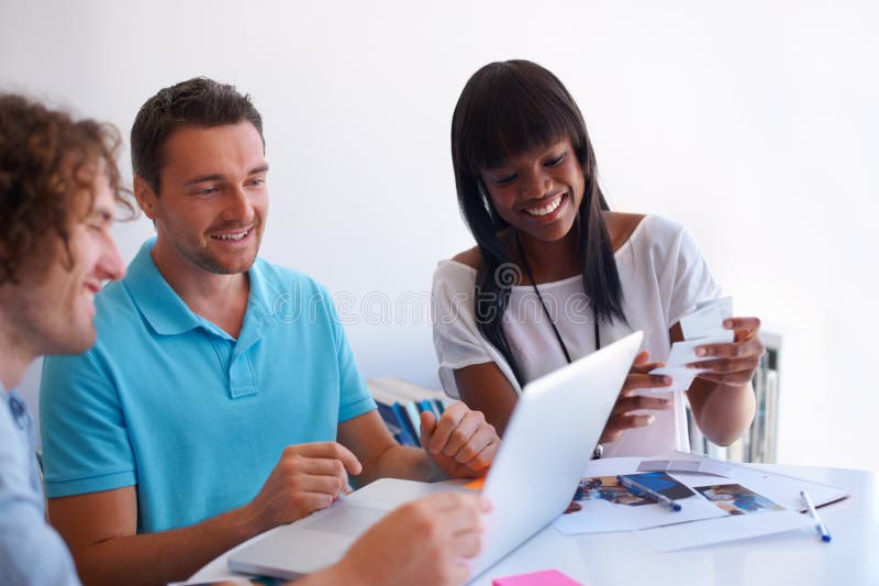 Going Over Their Proposal. Three Coworkers Gathered Around a Laptop in ...