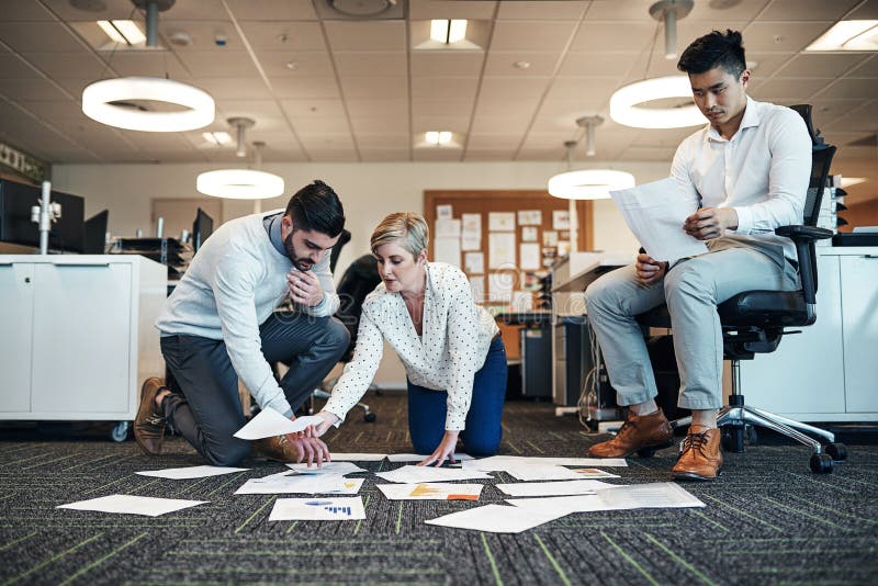 Going through the Paperwork Together. Businesspeople Working on ...