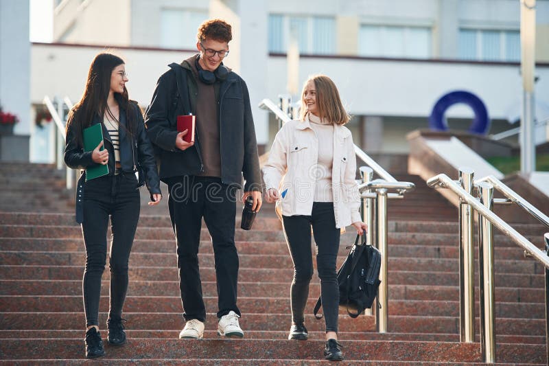 Going by the Stairs. Three Young Students are Outside the University ...