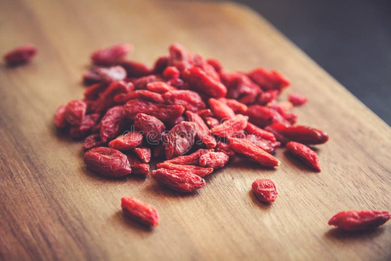 Goji Berries on a Cutting Board Stock Photo - Image of nutrition, pile ...