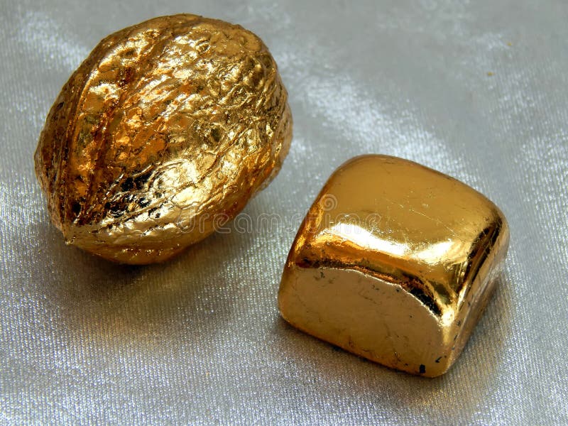 Gold Bar with a Nut from Gold Leaf on a White Background Stock Image ...