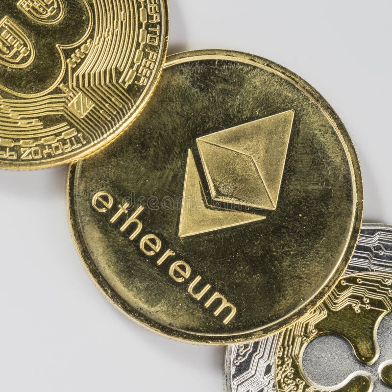 Gold Bitcoin, Etherium and Ripple Tokens in a Row Editorial Photography ...