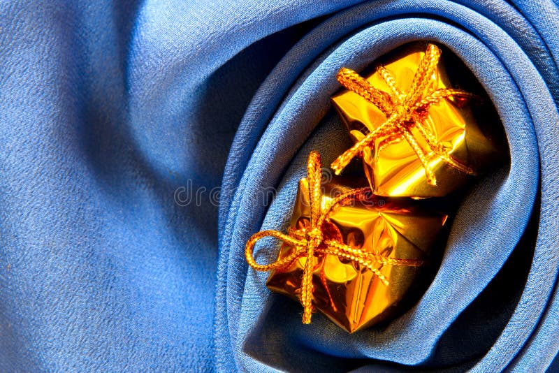 Gold Boxes Over Blue Silk Background Stock Image - Image of colour ...
