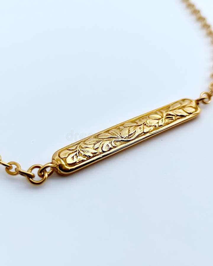 A Gold Chain with a Gold Bar that Has a Leaf Design on it Stock ...