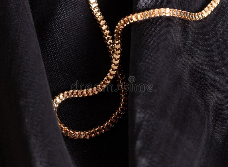 Gold Chain on Black Silk Fabric. Close-up Stock Photo - Image of ...