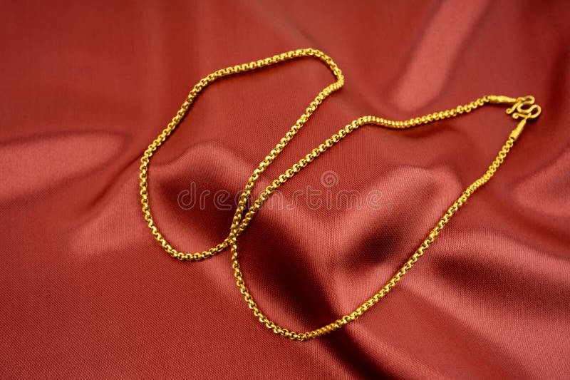 Gold Chain Necklace on Red Silk Textile Stock Photo - Image of textile ...