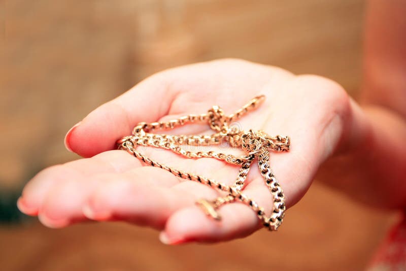 Gold chain on a palm stock image. Image of prompt, value - 22941083